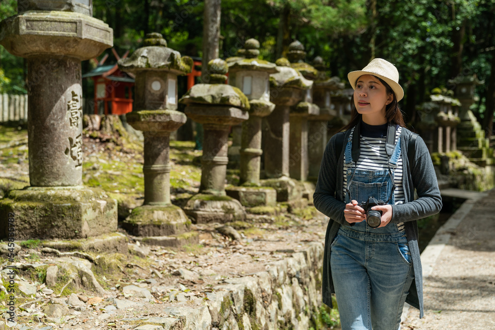 portrait of Asian Korean girl photographer admiring a line of Japanese ...