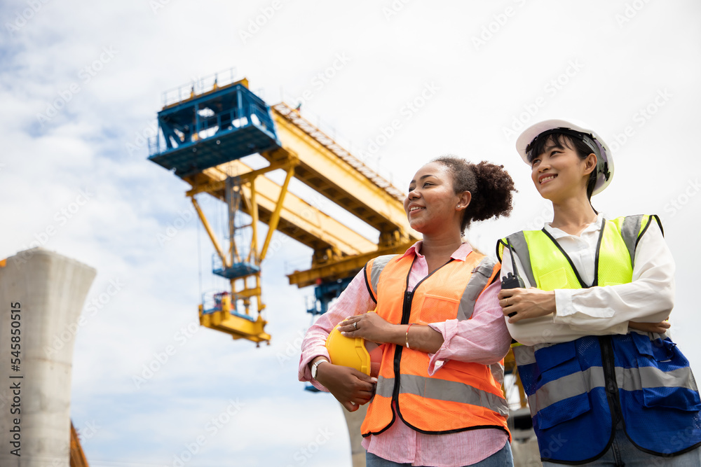 Diversity of architectural engineer woman with assistant plan and ...