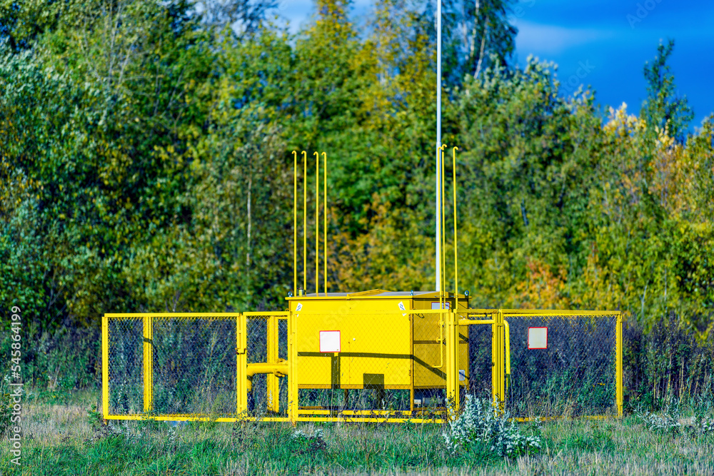 The gas distribution station in the forest is protected by a fence ...