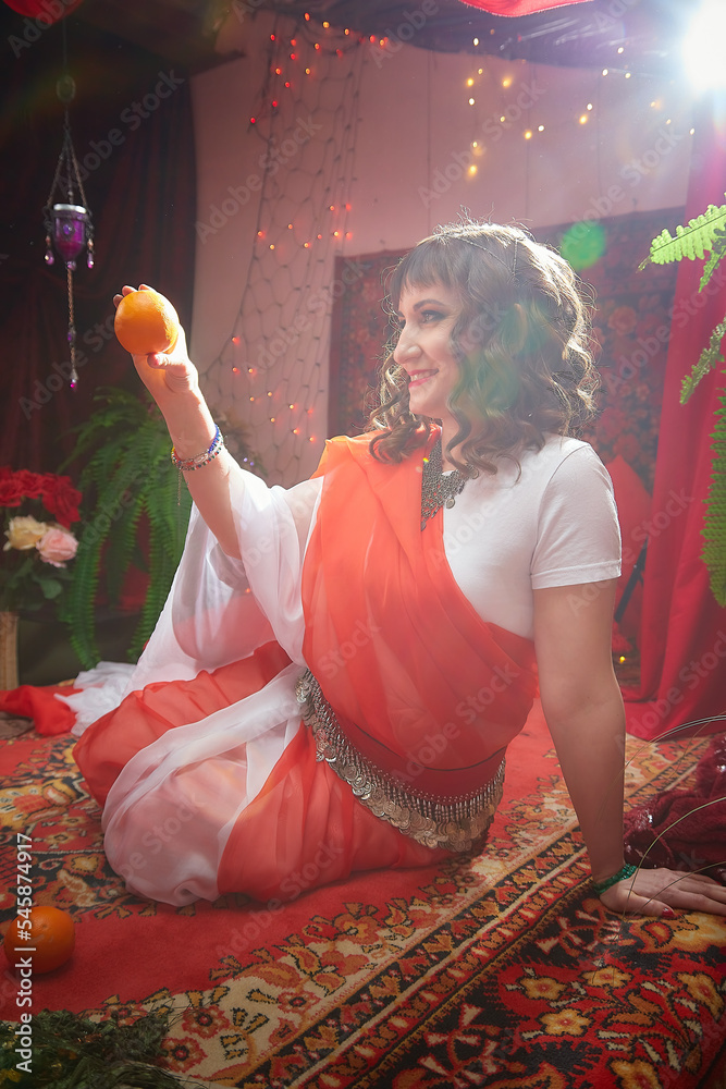 Beautiful European girl looking like Arab woman in red room with rich ...