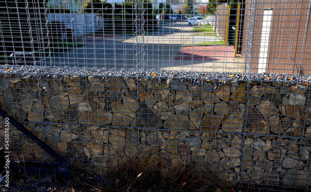 gabion wire basket, cages. fence in the front garden with a natural ...