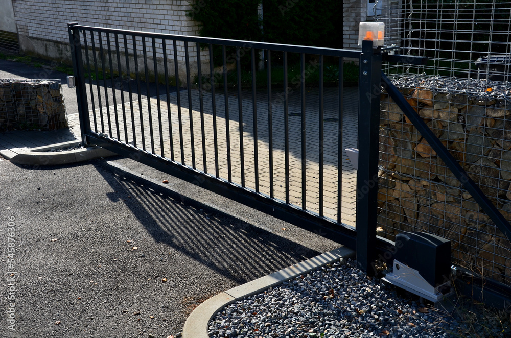 entrance to the yard to the parking lot through a low sliding gate. the ...