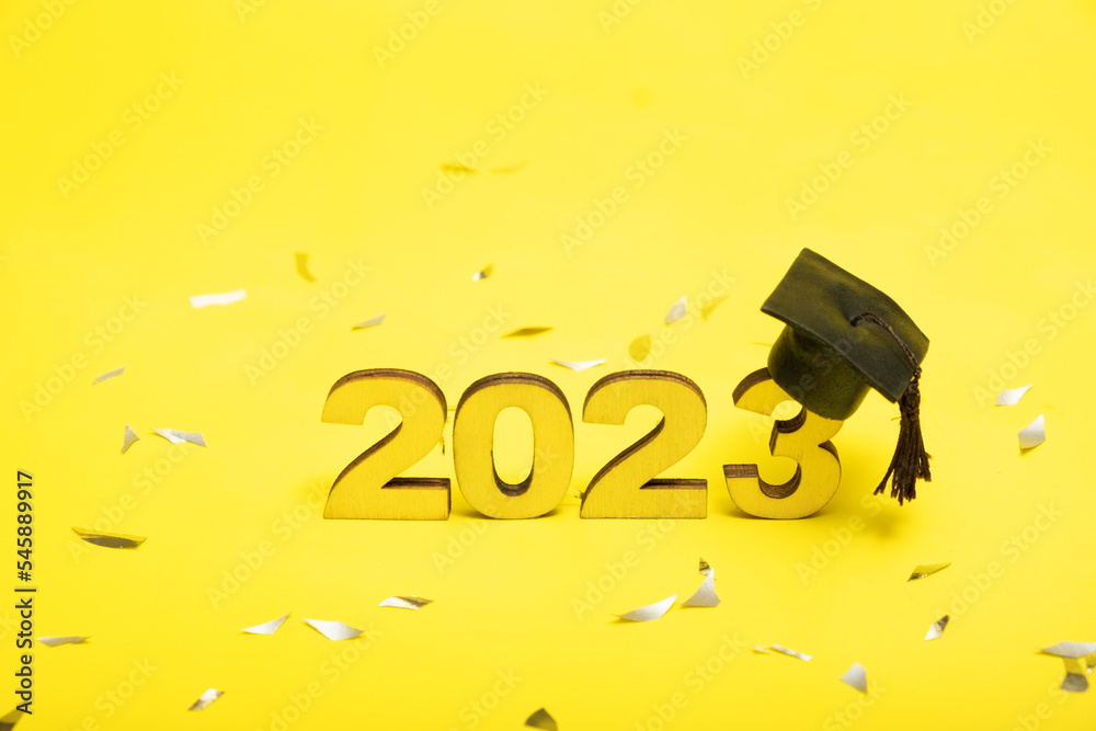 Class of 2023 concept. Numbers 2023 with black graduated cap on yellow ...