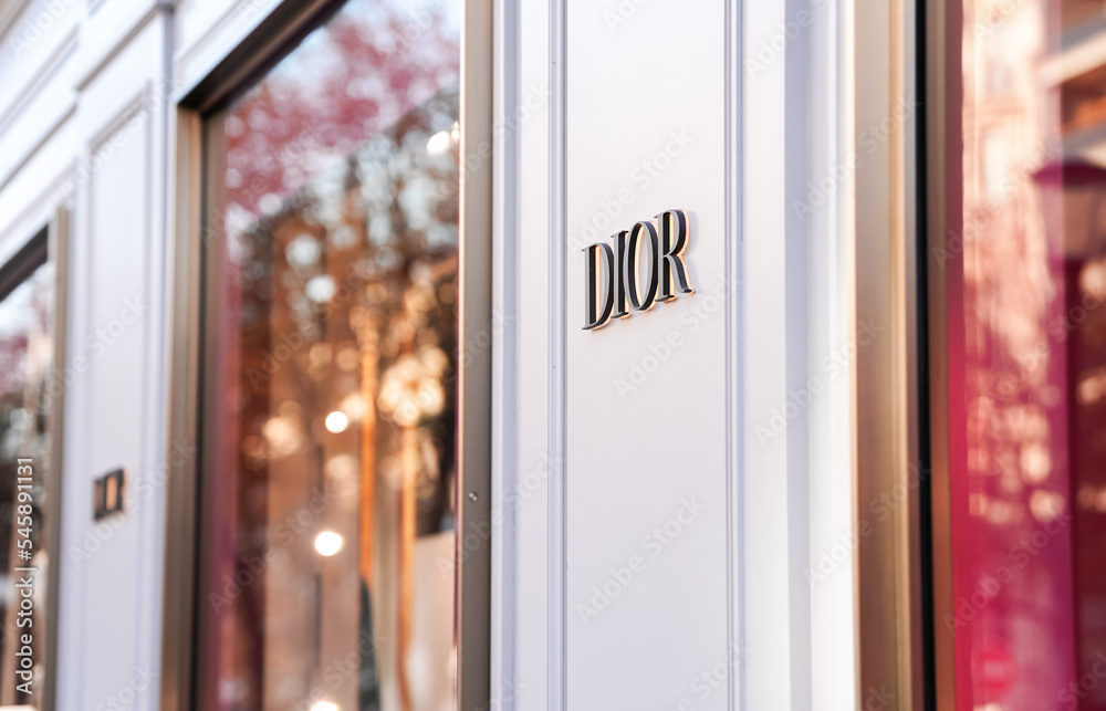 The logo sign of Dior luxury clothing company on top of a store from ...