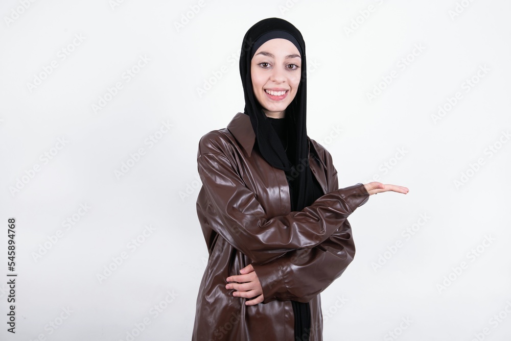 young beautiful muslim woman wearing hijab and leather jacket over ...