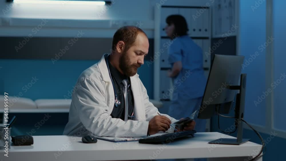 Physician doctor analyzing radiography typing medical expertise on ...