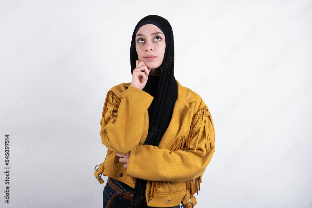 Face expressions and emotions. Thoughtful young beautiful muslim woman ...