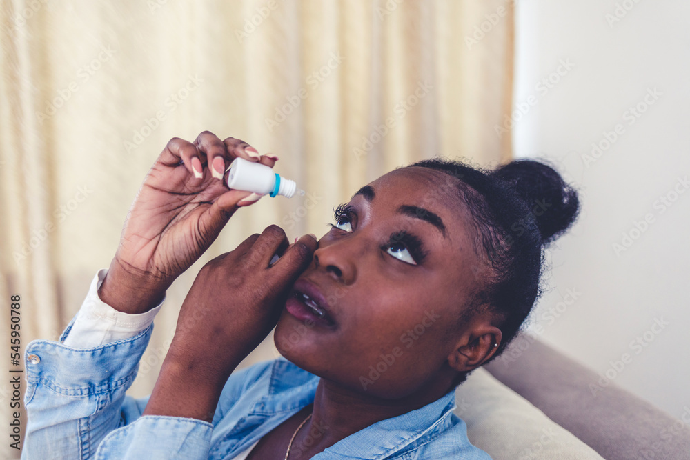 Young woman putting eye drops. Closeup of beautiful woman applying ...