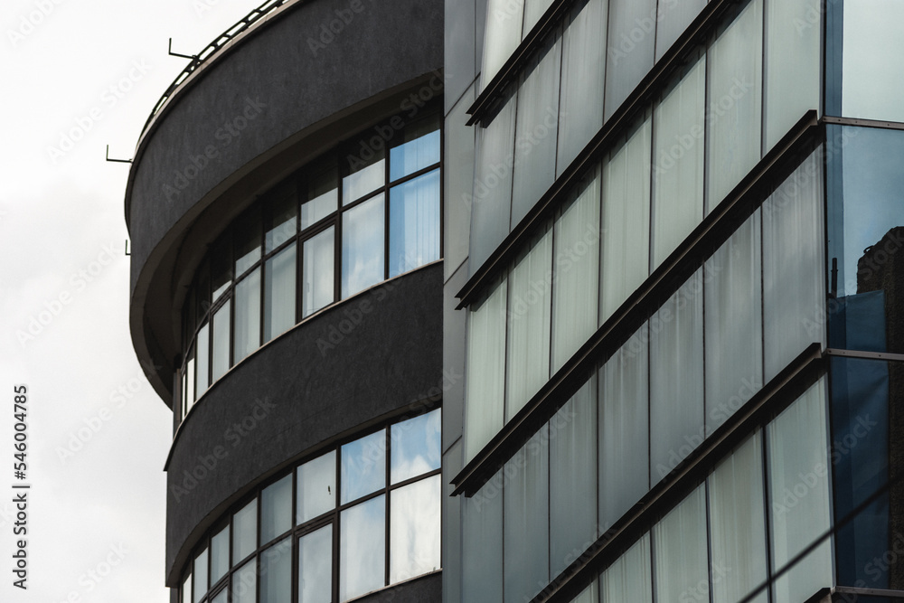 Front wall of a business building full of reflective windows. Corporate ...