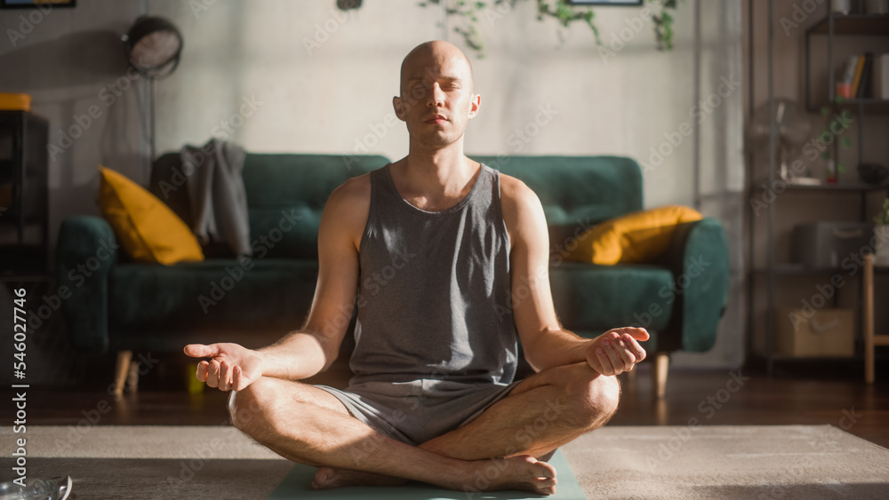 Athletic Young Man Exercising, Doing Meditation in the Morning in His ...