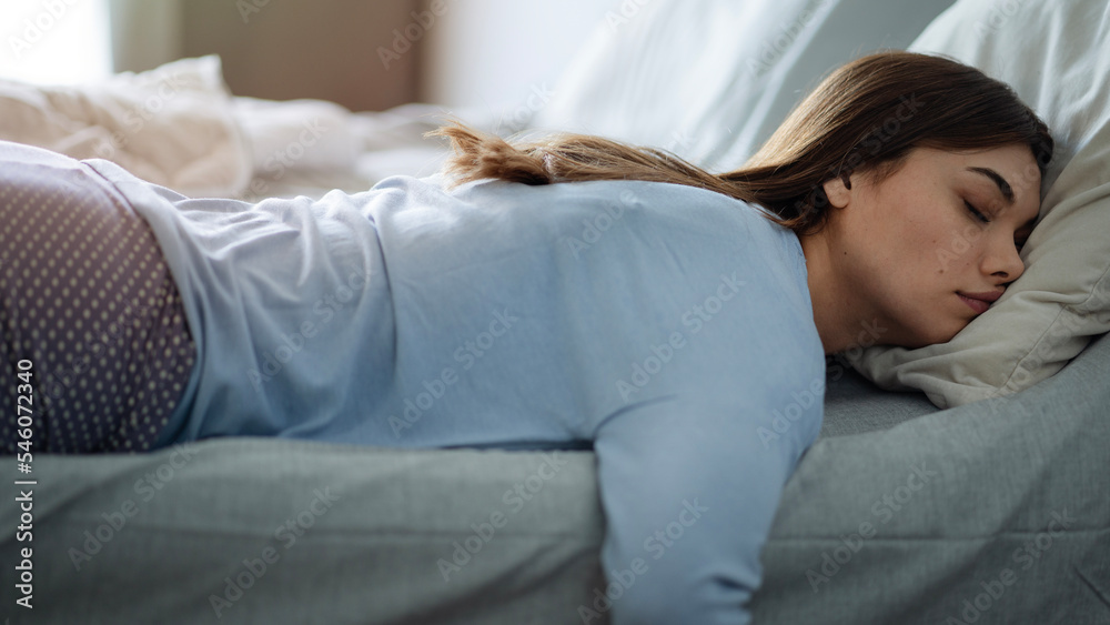 Young woman sleeping on the bed Stock Photo | Adobe Stock