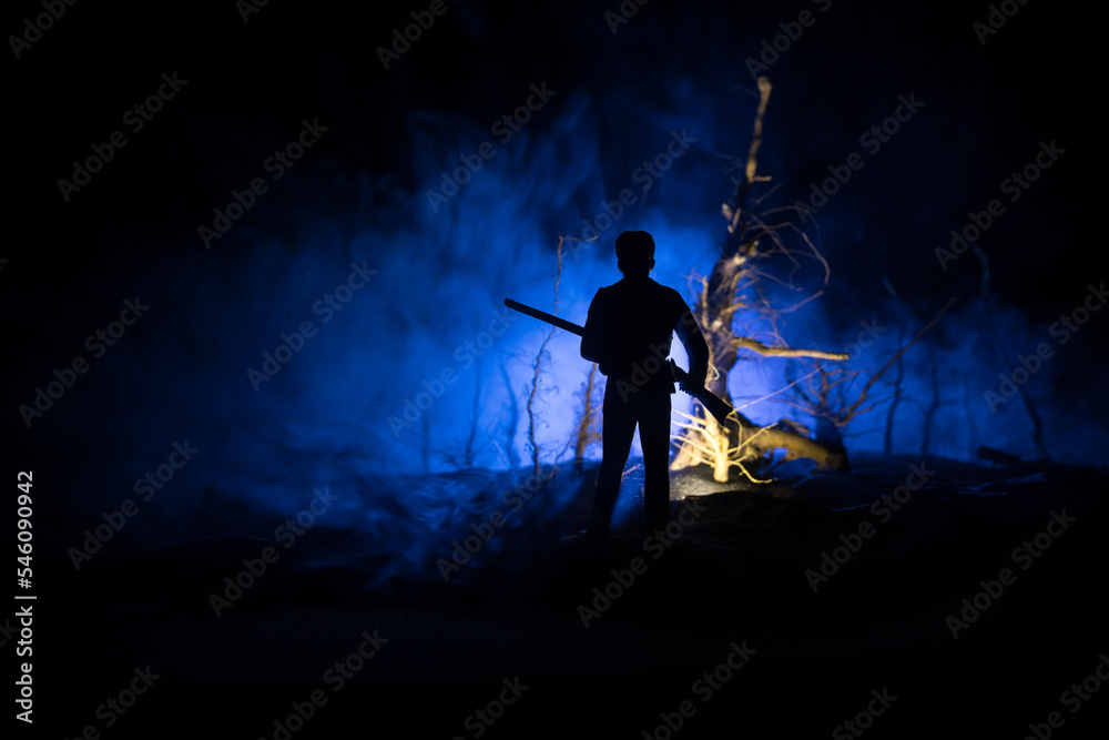 Silhouette of person standing in the dark forest. Horror halloween ...