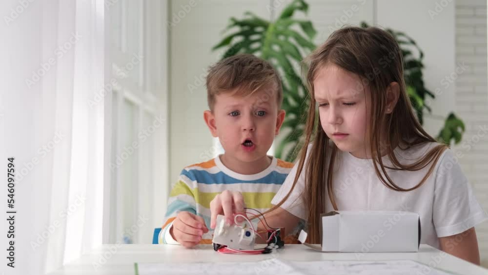 Little boy and girl is engaged or studying science with the help of ...