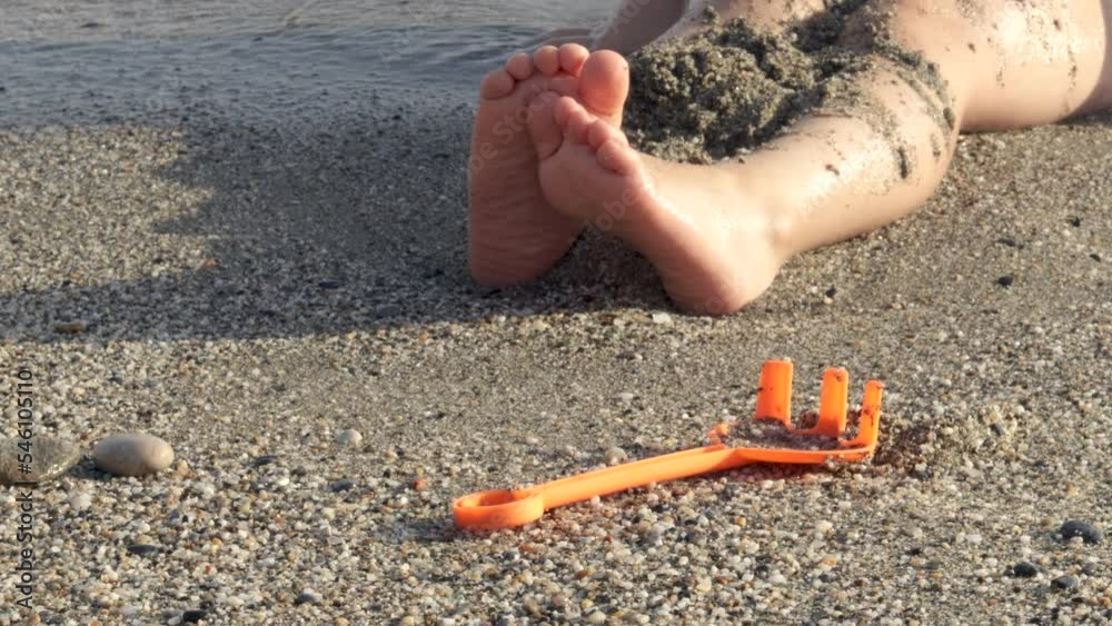 kid child boy having fun on sands beach seashore digging throwing wet ...