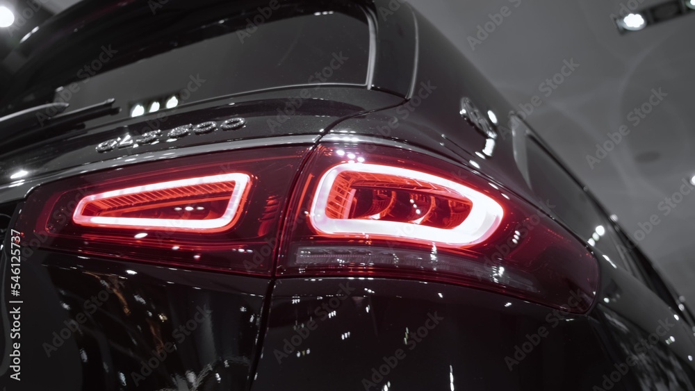 Close up cinematic view of rear red LED brake light of new luxury ...