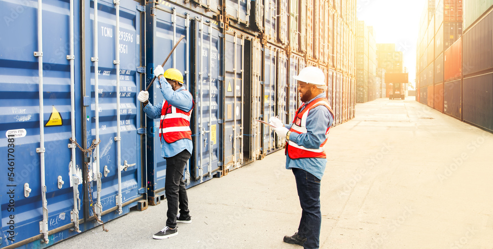 Two African American male workers inspect suspicious and dangerous ...