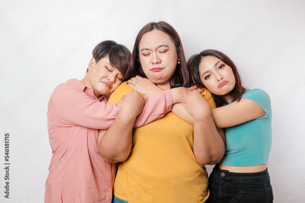 A portrait of three friends looking sad crying wiped her tears and hug ...