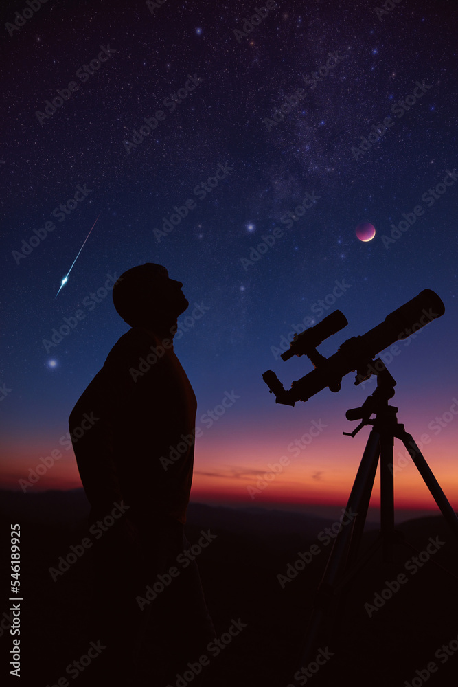 Man with astronomy telescope looking at the night sky, stars, planets ...