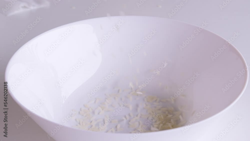 Rice grains that have been cleaned of husks into bowls ready to be ...