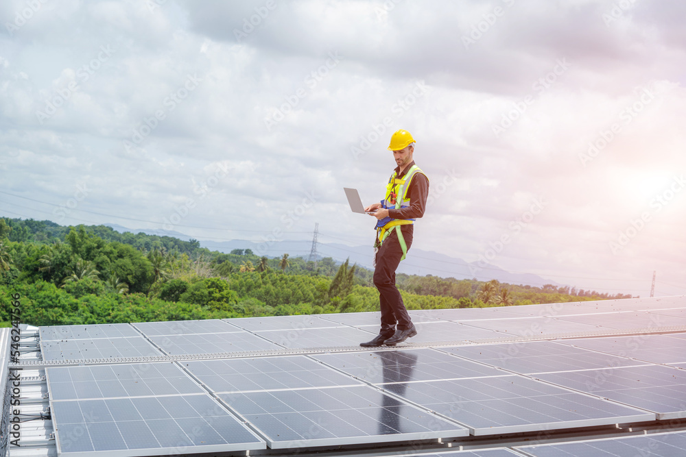 Engineer working and maintenance with solar batteries near solar panels ...