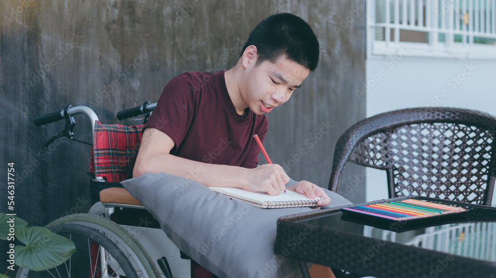 Young man with a disability enjoying training of hand and finger ...