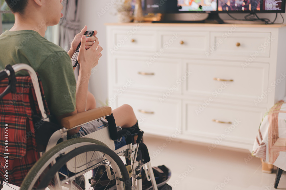 Hands of Young man with a disability using remotcontro for TV in living ...