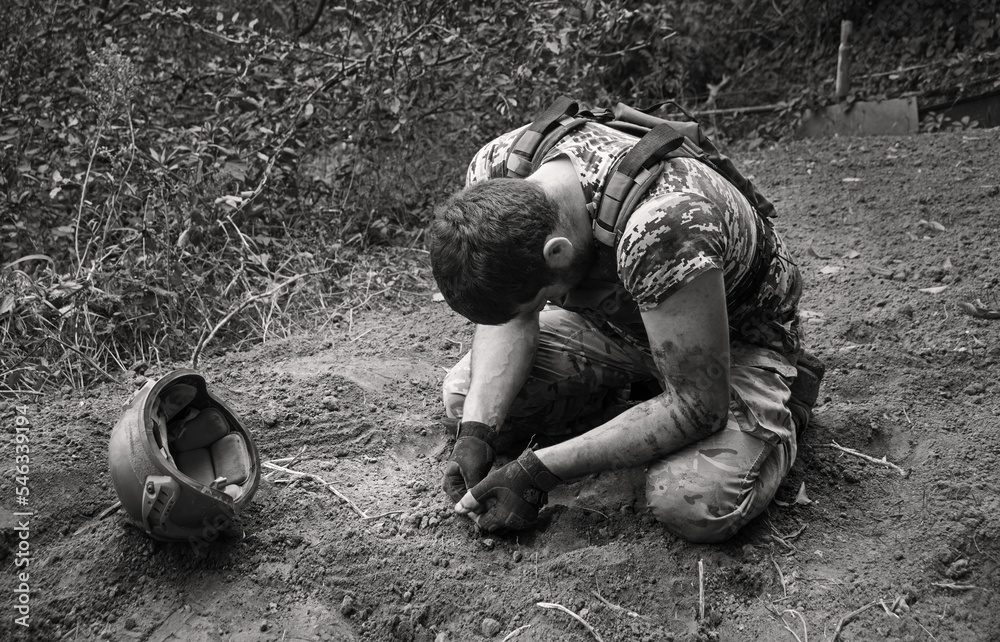 Sad soldier sits on the ground Stock Photo | Adobe Stock