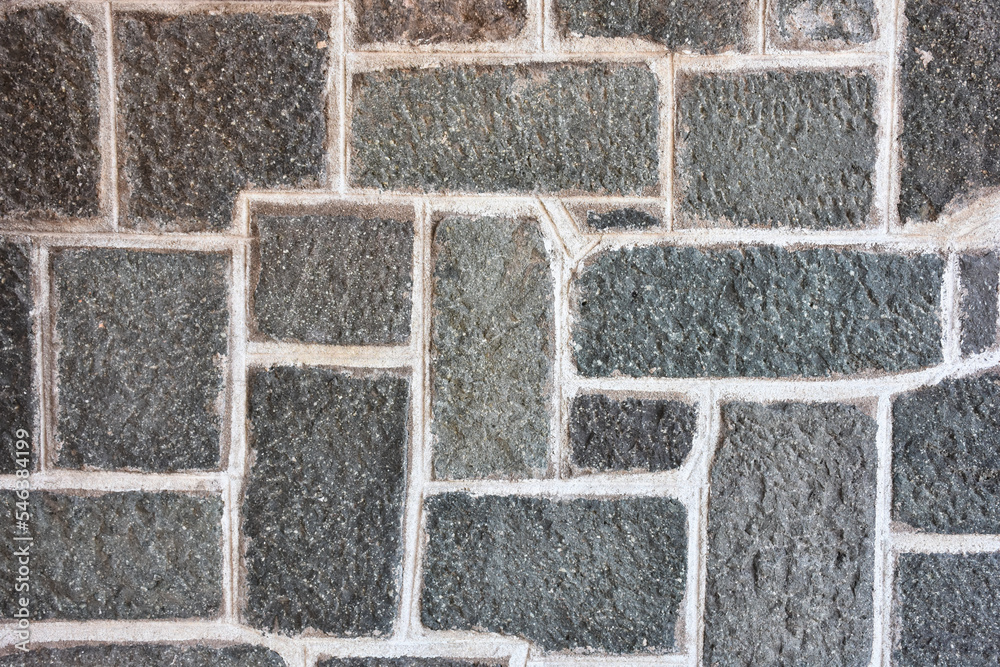 Several rows of a rough textured concrete block wall as background ...