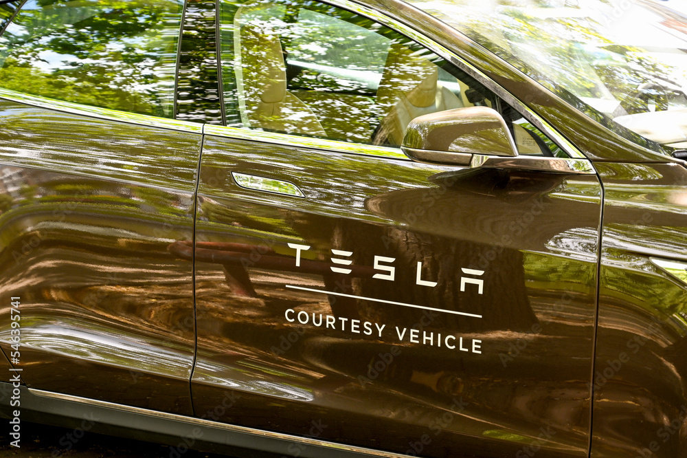 Sign on the side of a Tesla electric car provided to customers of a ...