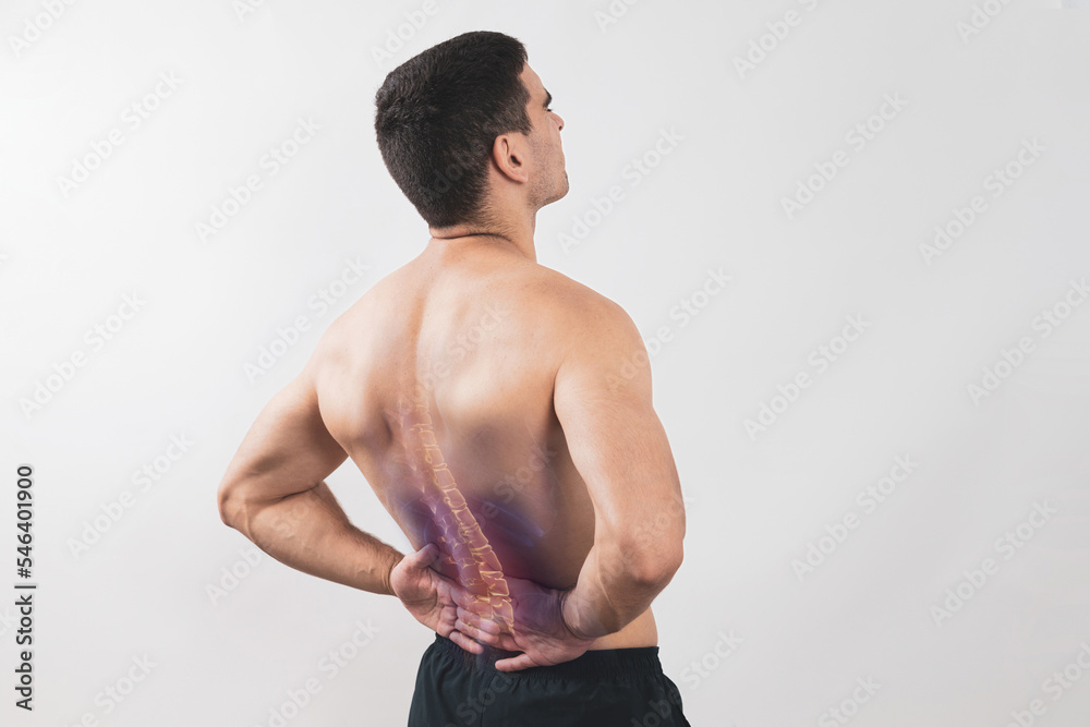 man keeps his hands behind his back, pain in the back, pain in the ...