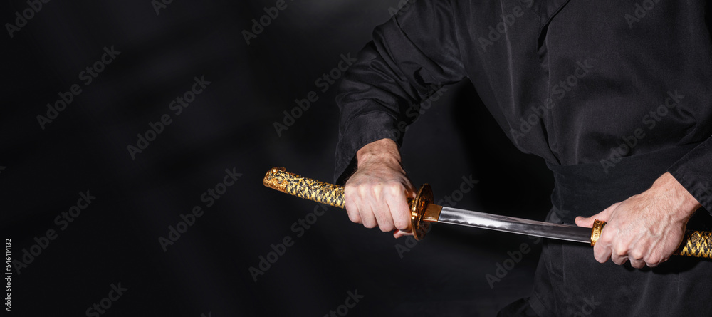 The samurai holding a Japanese katana sword, banner. Photo of a warrior ...