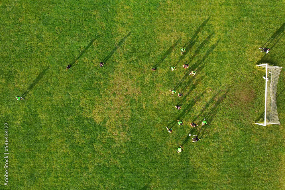 Aerial drone view of a sports field and a football team that practices ...