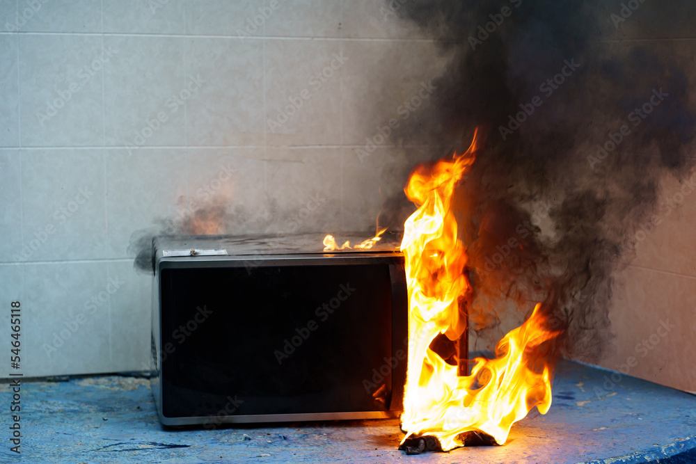 microwave oven on fire. the concept of fire in the kitchen and ...