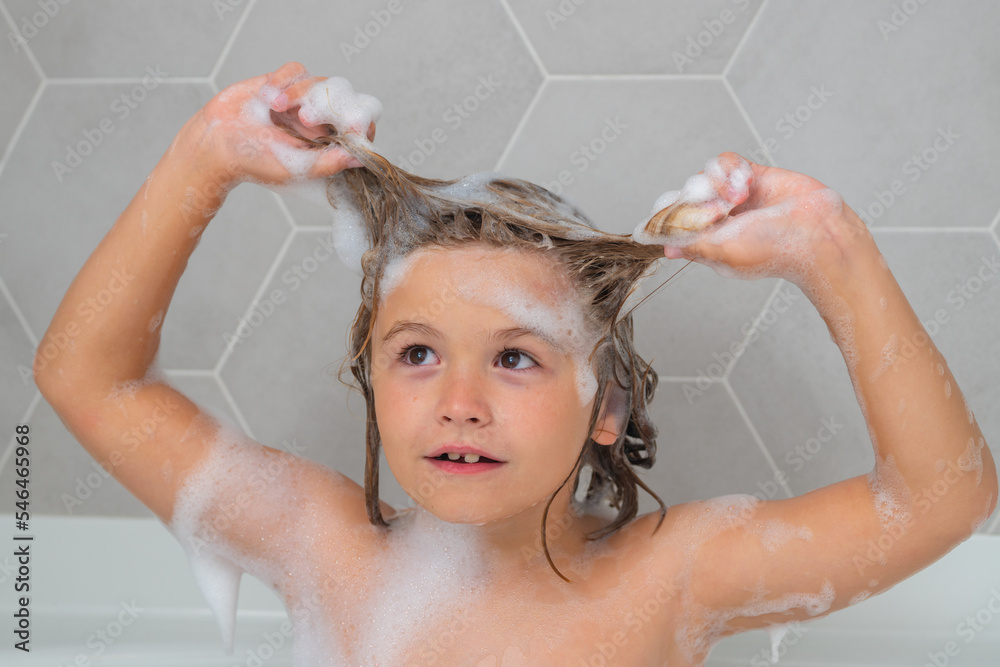 Kid washing hair. Soap on child head. Child face in foam. Kid bathing ...