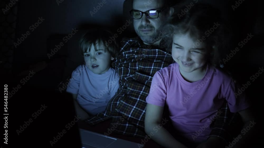 Happy Family While Watching TV on Laptop. Father with Son and Daughter ...