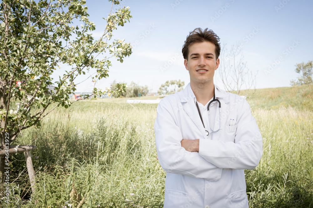 young sympathetic doctor with white coat and stethoscope around his ...