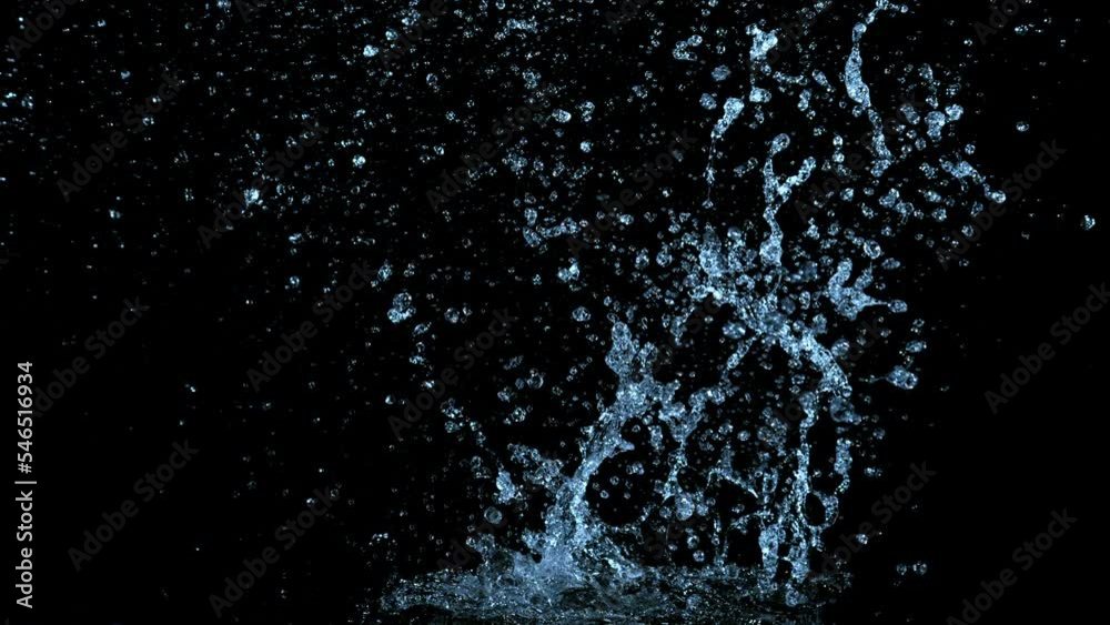 Super slow motion of splashing water crown shape on black background ...