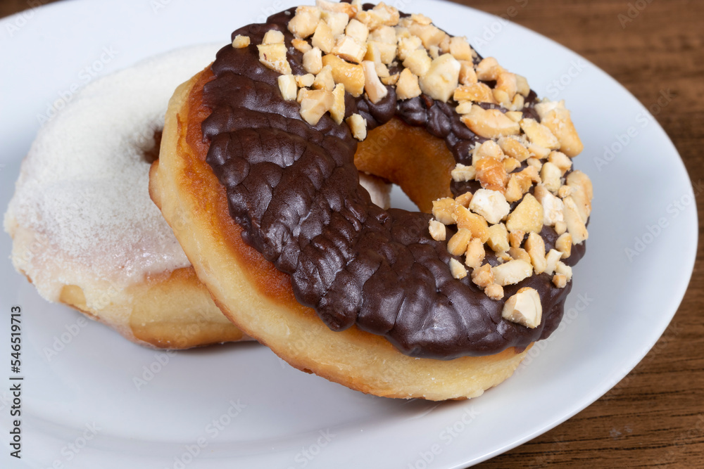 Sweet donuts with cream and powdered milk frosting and another donuts ...