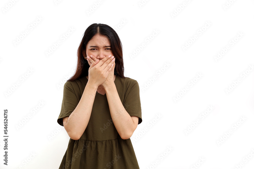 Sad young asian woman standing while crying and covering her mouth ...