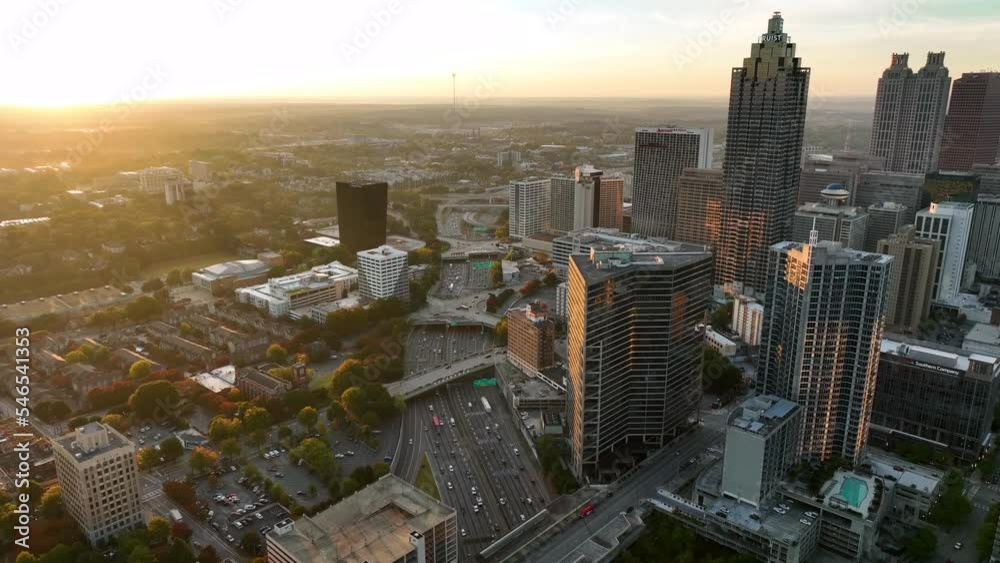 Downtown Atlanta cityscape in warm golden hour light. Aerial of traffic ...