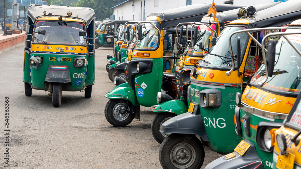Many CNG-based auto rikshaws are at the taxi stand in Vijayawada, India ...