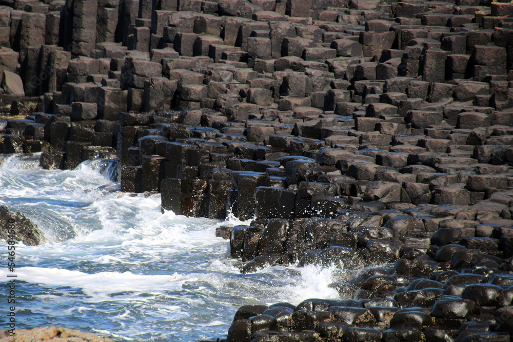 Hexagonal basalt stone pillars at the Giant's Causeway in Northern ...