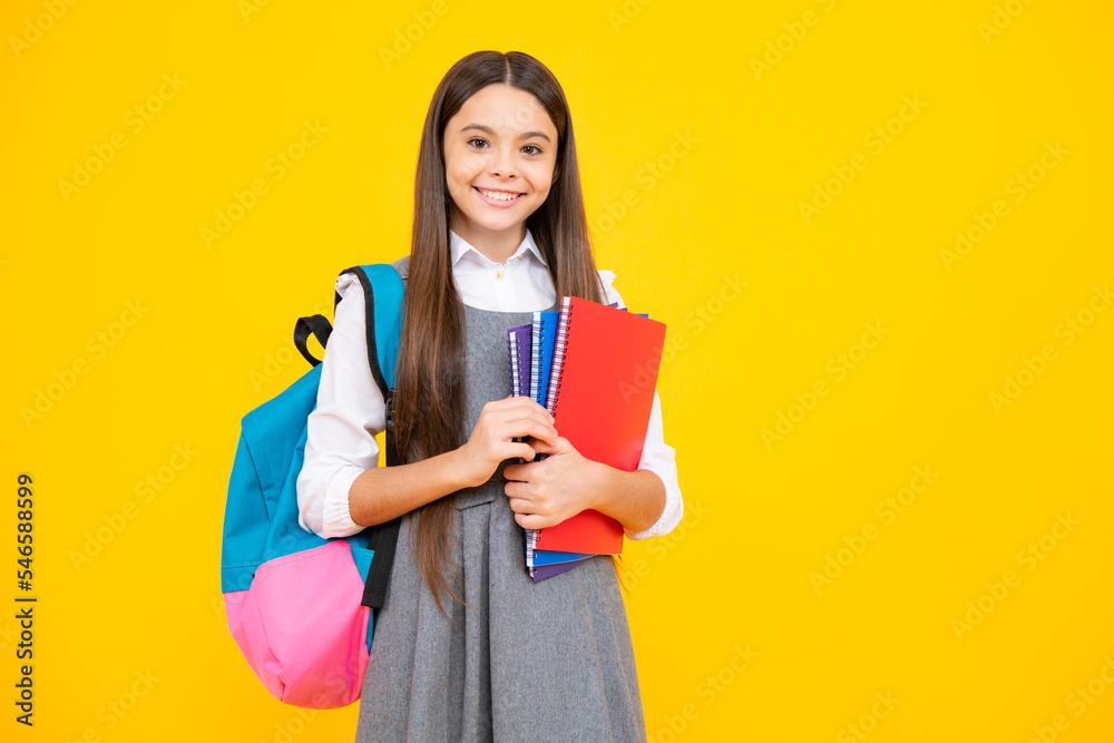 Schoolgirl, teenage student girl hold book on yellow isolated studio ...