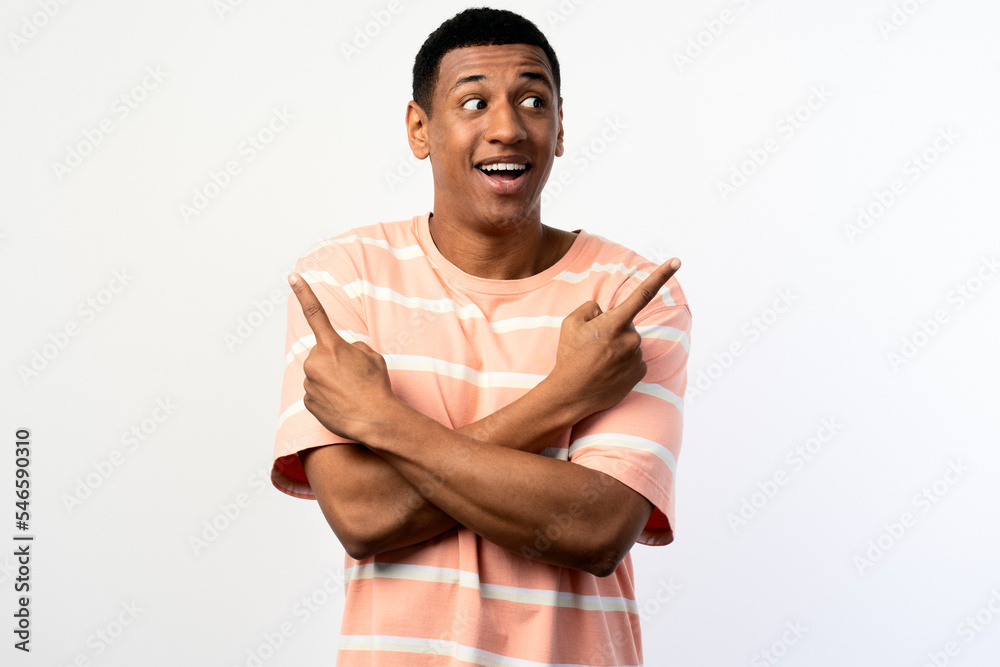 Happy excited young man looking away pointing up with fingers hand ...