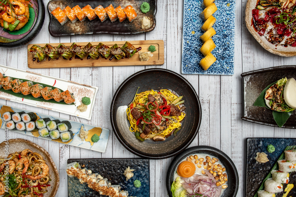 Japanese peruvian fusion food dish set with ceviches, bao bread, stew ...