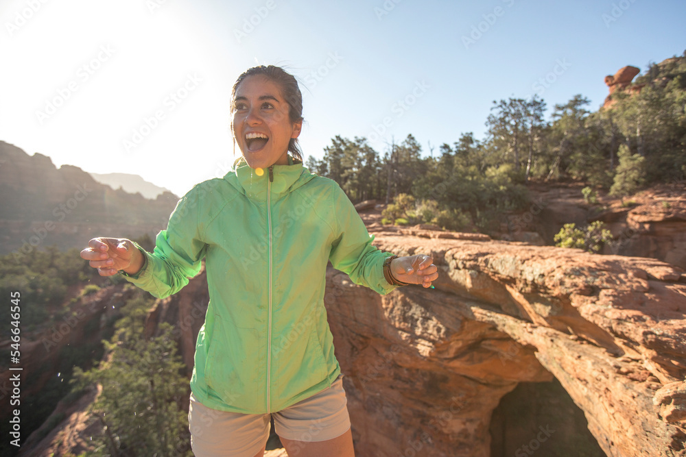 Foto de Female hiker laughing after splashing water on her face during ...