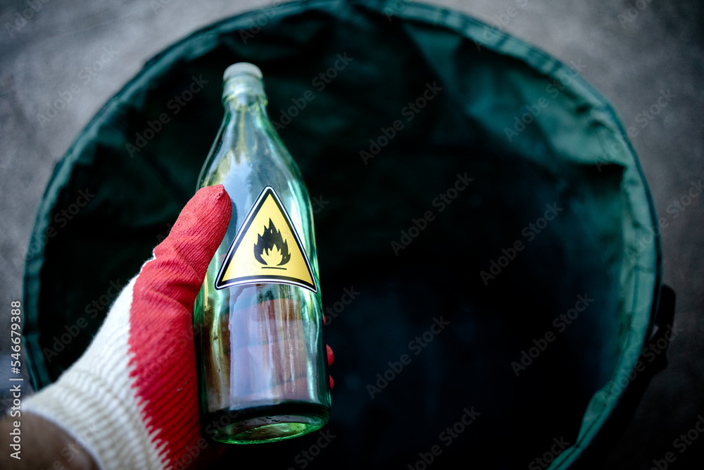 A hand with a molotov cocktail. Disposal of flammable liquids in the ...