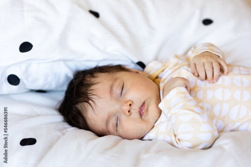 Newborn Baby Rests In Polka Dotted Bed Stock Photo | Adobe Stock
