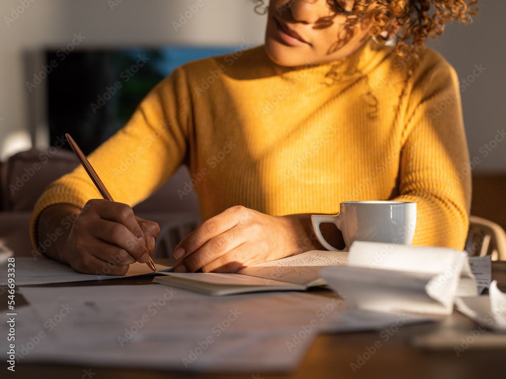 Crop businesswoman making notes near notepad and cup Stock Photo ...