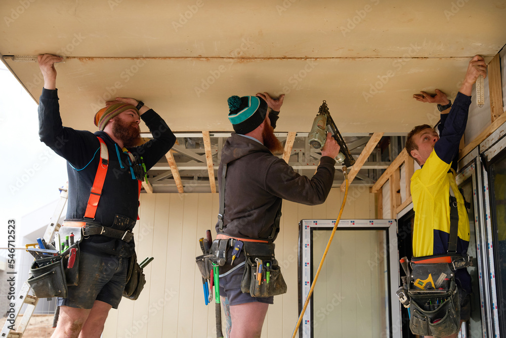 Tradies working as a team on building site Stock Photo | Adobe Stock